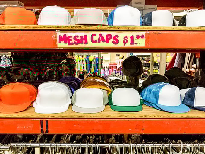 The hat wall: where $1 buys you both sun protection and style points. Mesh caps waiting to become someone's favorite headwear.