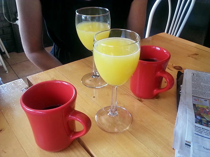 Morning mimosas and coffee in those classic red mugs &ndash; because sometimes breakfast deserves a standing ovation rather than a quick bow.