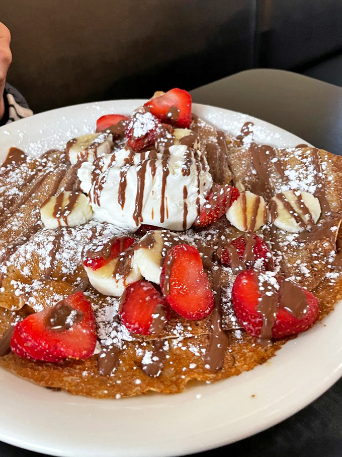 A breakfast that doesn't pretend to be healthy&mdash;Nutella, strawberries, bananas, and whipped cream on what appears to be a crepe. Dessert? Breakfast? Yes.