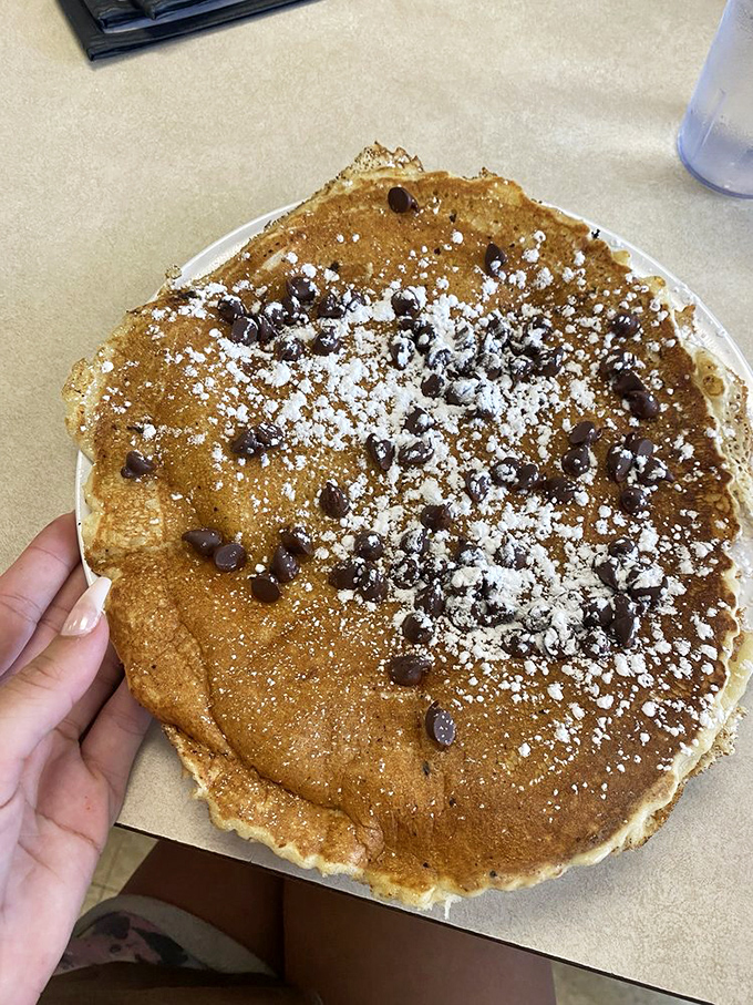 This chocolate chip pancake isn't just breakfast&mdash;it's dessert with morning privileges, dusted with powdered sugar like freshly fallen snow.