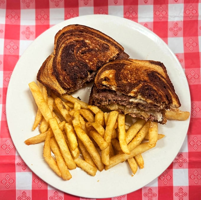 This patty melt doesn't just sit on the plate&mdash;it commands attention with its perfectly grilled marble rye and melty cheese situation. 