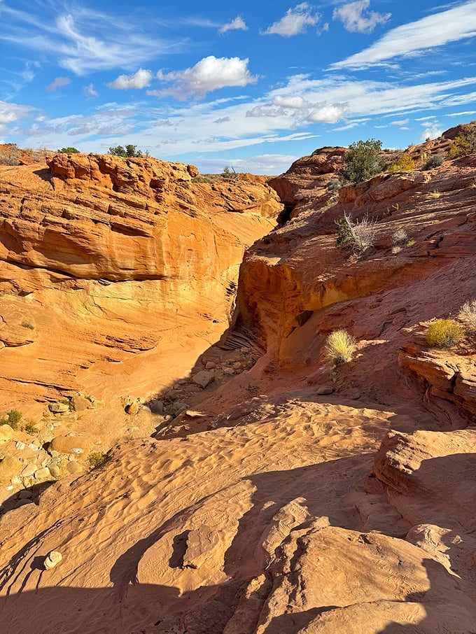Peek-A-Boo Slot Canyon offers a hiker's version of threading the needle—squeeze through to discover nature's hidden cathedral.