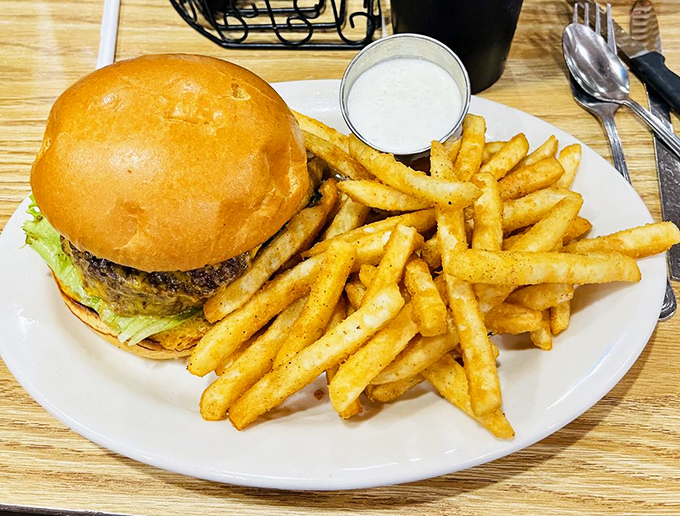 Burger perfection doesn't need fancy frills. This hand-formed patty on a pillowy bun with golden fries is America's favorite lunch for good reason.