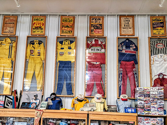 A rainbow of racing history hangs on display. Each suit tells tales of white-knuckle turns, photo finishes, and the occasional wall encounter.