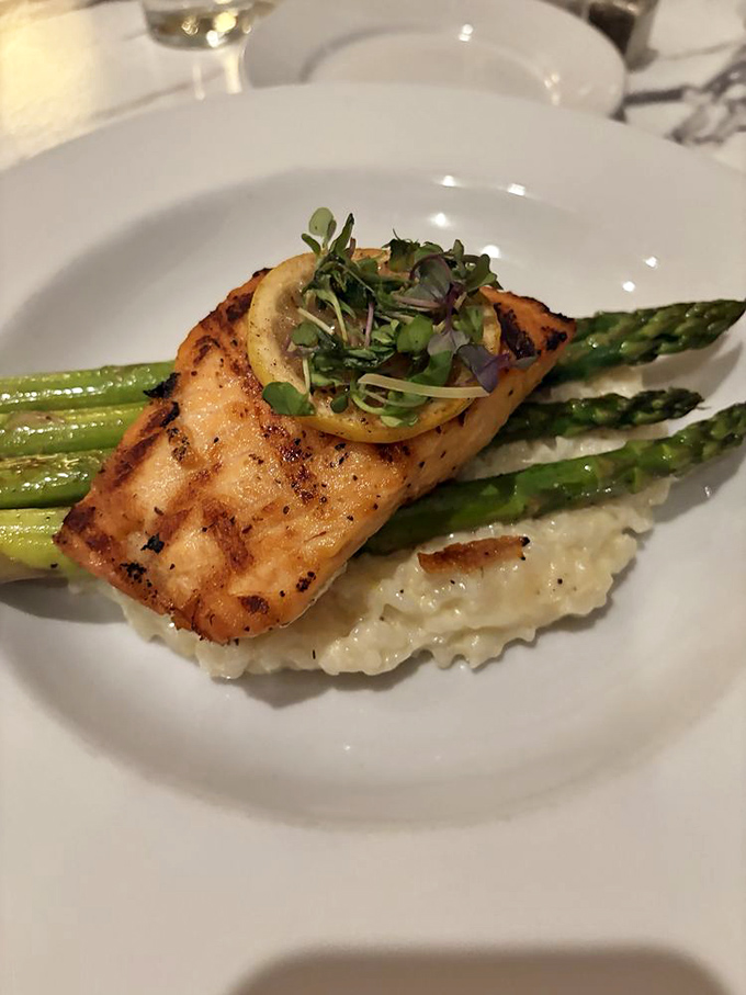 Perfectly seared salmon perched atop risotto like it's posing for the cover of "Sophisticated Seafood Monthly."
