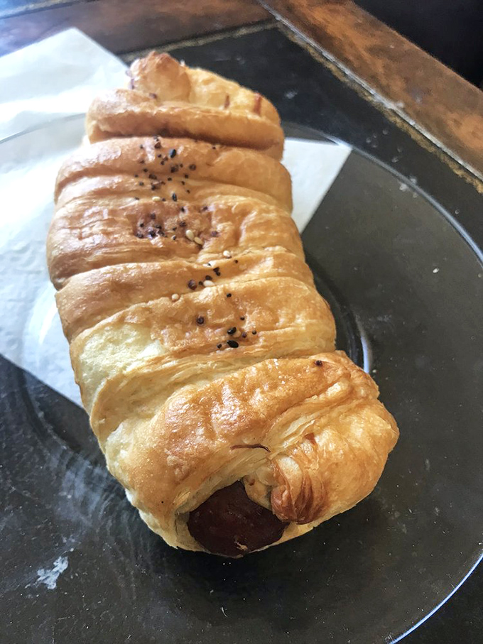 This sausage roll is what happens when breakfast meets brilliant engineering. Flaky layers cradle savory filling in a hand-held masterpiece of morning cuisine.