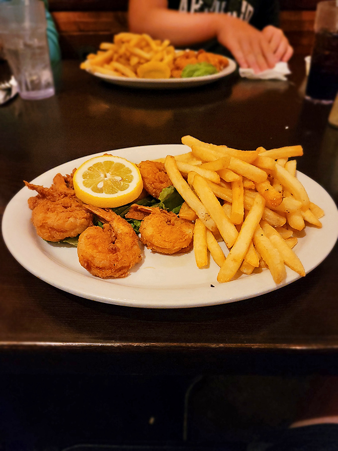 Golden-fried shrimp that snap with freshness, paired with crispy fries. The lemon wedge isn't just garnish&mdash;it's the perfect finishing touch.