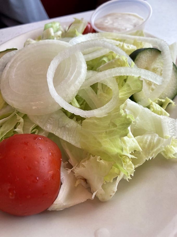 Even the side salad gets respect here&mdash;crisp lettuce, vibrant tomato, and those perfect rings of onion that make you forget you ordered something healthy.