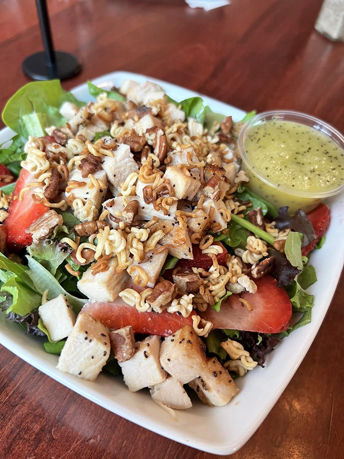 A salad that doesn't apologize for bringing strawberries to the party—bright, fresh, and proof that healthy eating doesn't have to be punishment.