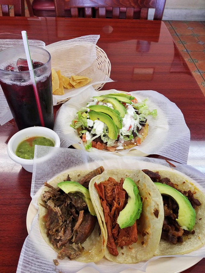 A trio of tacos alongside a tostada&mdash;the Mexican equivalent of the perfect surf and turf, with avocado adding creamy richness to each bite.