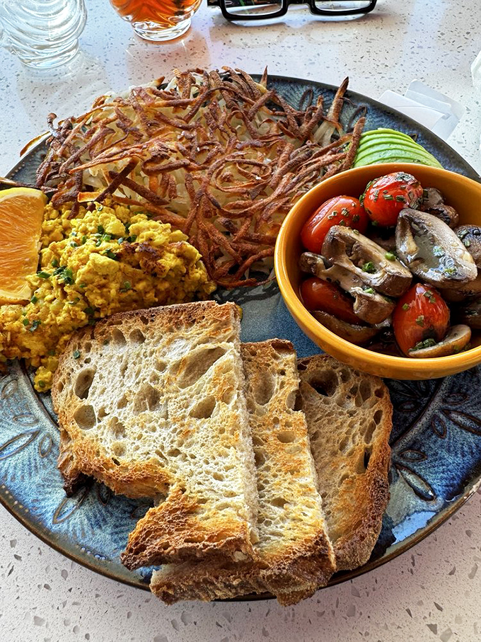 The breakfast standard reimagined&mdash;crispy hashbrowns, perfectly scrambled eggs, and artisanal toast that makes Wonder Bread weep with inadequacy.