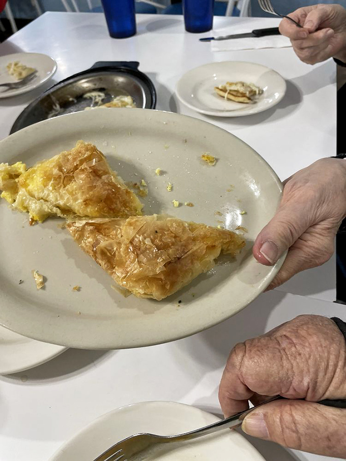 Flaky, buttery phyllo that shatters like delicate glass, revealing a creamy cheese filling. This tiropita doesn't need to show off—it knows exactly how good it is.