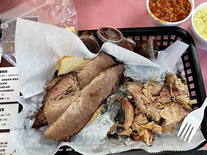 The Two Meat Dinner brings together brisket and pulled pork like old friends at a reunion, with beans and slaw playing perfect supporting roles.