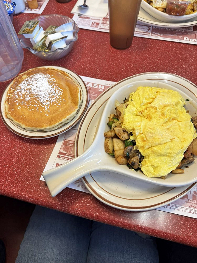 A breakfast balancing act &ndash; fluffy eggs atop a garden of saut&eacute;ed vegetables. That golden pancake on the side isn't playing second fiddle to anyone.