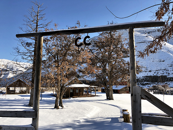 Winter transforms the old ranch entrance into a snow globe scene straight out of a Western Christmas card.