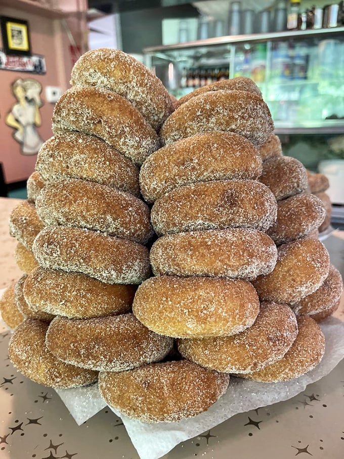 That mountain of sugar-dusted donuts isn't just a display &ndash; it's a siren call to everyone who walks through the door. Resistance is futile.