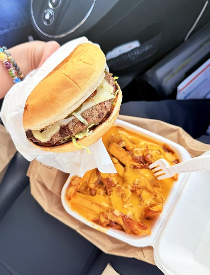 Car eating at its finest. Nothing says "I've made excellent life choices today" like balancing a perfect burger in one hand and diving into chili cheese fries with the other.
