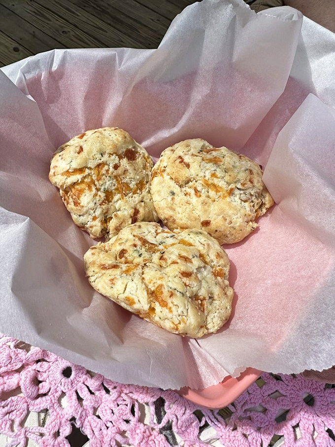 Golden, flaky cheddar biscuits nestled in pink tissue paper&mdash;Southern comfort that fits in your palm but expands in your heart.