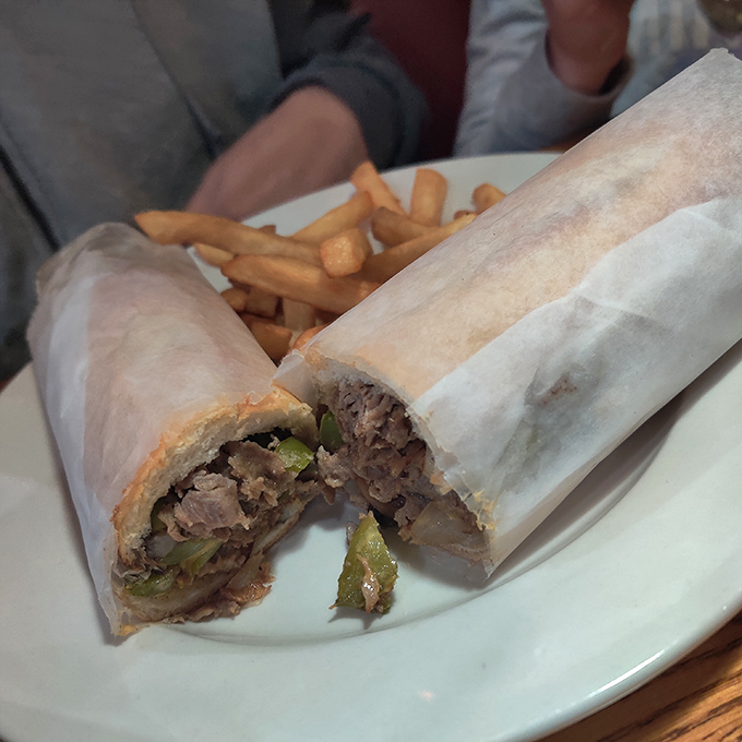 A proper cheesesteak wrapped in paper&mdash;the way the sandwich gods intended. The kind of handheld meal that requires a stack of napkins and zero regrets.