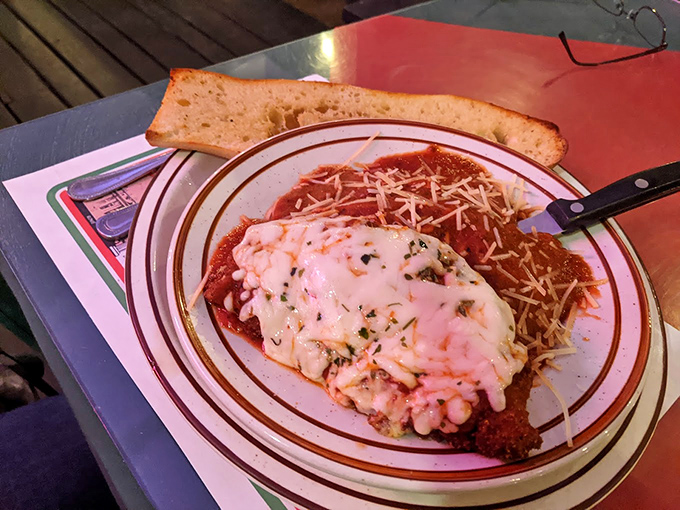 This chicken parmesan has achieved the impossible trifecta: crispy exterior, juicy interior, and enough cheese to make Wisconsin nervous.