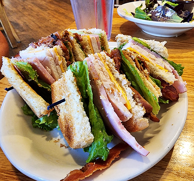 The club sandwich stands tall and proud, a skyscraper of sandwich engineering that requires both hands and possibly a fork to tackle.