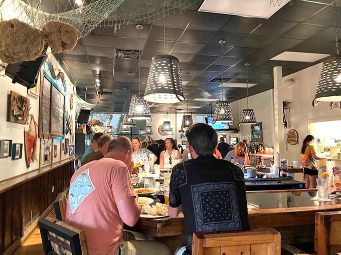 The horseshoe bar isn't just where food happens&mdash;it's where strangers become friends united by the universal language of "pass the hot sauce."