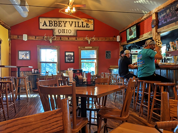 The dining area whispers "stay awhile" with its wooden chairs, polished floors, and that "Abbeyville" sign watching over happy conversations.