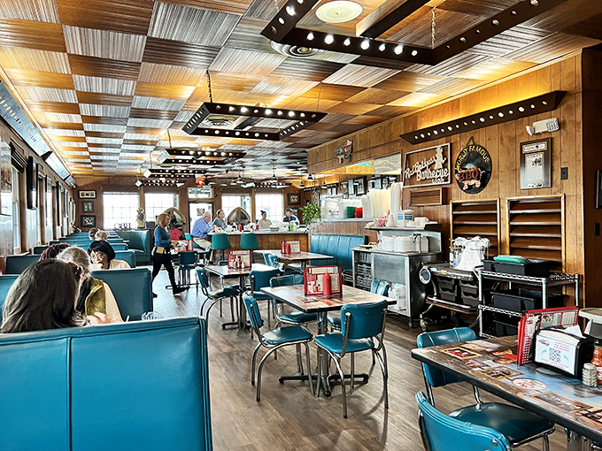 The dining room hums with conversation beneath that distinctive patchwork ceiling. Notice how nobody's looking at their phones? That's the power of great barbecue.