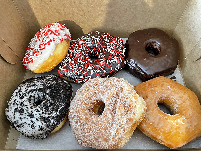 Half a dozen reasons to smile, each one glazed, frosted, or sprinkled to perfection. The hardest part is deciding which one to eat first. 