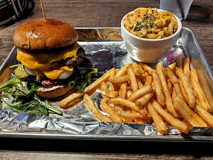 A burger that doesn't just satisfy hunger but fulfills dreams, flanked by golden fries and mac & cheese that refuses to be just a side dish.