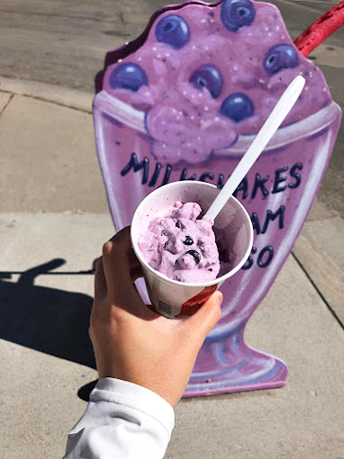 A cup of huckleberry goodness with a side of small-town charm. The purple hue promises a flavor adventure you can't find at chain stores.