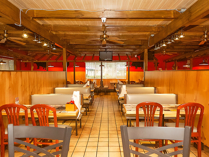 Down the corridor of comfort where wooden beams guide hungry travelers to their booths. The red walls aren't just decoration&mdash;they're stimulating your appetite.