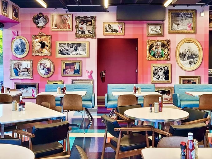 Pink walls adorned with eclectic framed art create a space that's equal parts whimsy and warmth. Like dining inside a stylish friend's daydream.