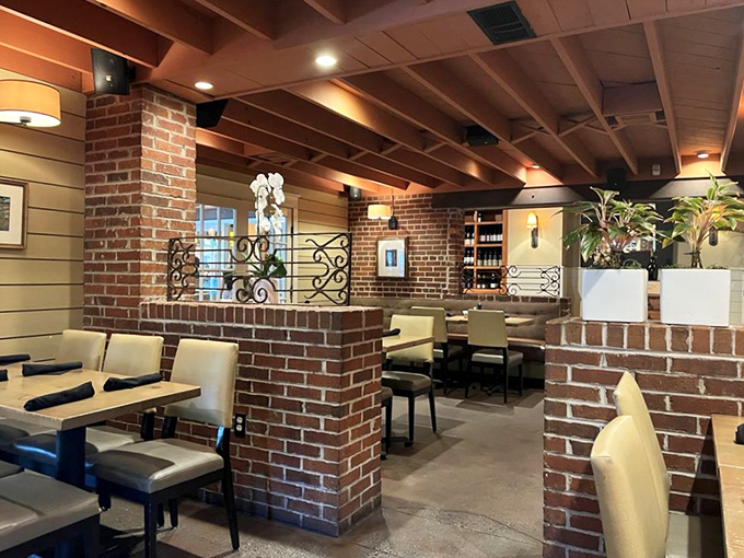 Brick walls, warm lighting, and thoughtful divisions create intimate dining pockets within the larger space&mdash;like being in your fancy friend's exceptionally well-designed home.