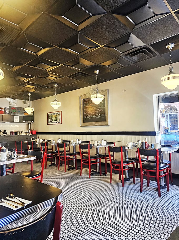 The distinctive diamond-patterned ceiling watches over diners like a geometric guardian angel, while pendant lights cast a warm glow on breakfast dreams.