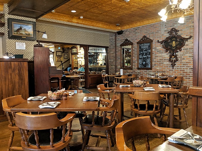 Brick walls and pressed tin ceilings frame a dining room where Charles Dickens would feel right at home, pint in hand.