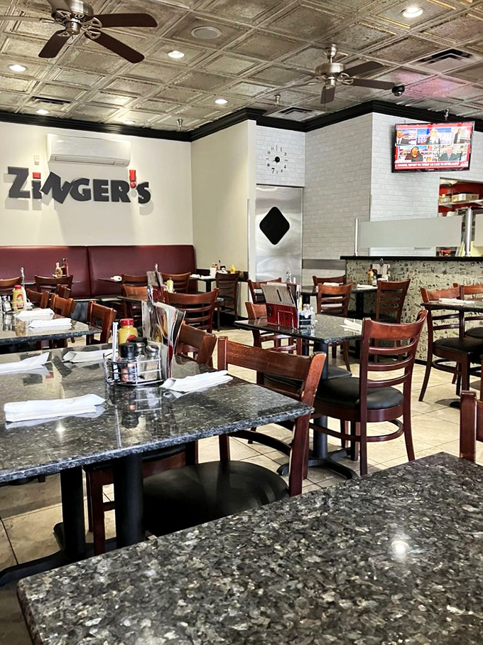 The dining room balances modern touches with old-school charm, where granite tables meet classic deli aesthetics.