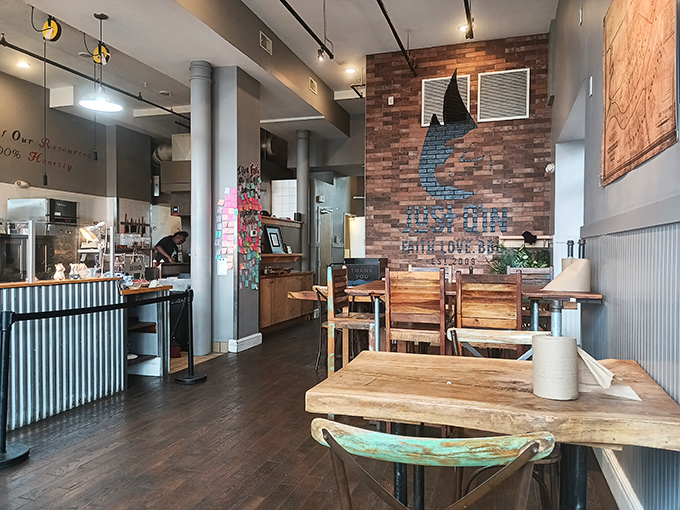 The exposed brick wall bearing the Just Q'in logo serves as both d&eacute;cor and mission statement: Faith, Love, BBQ.