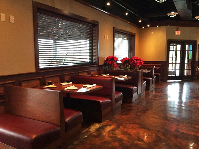 Booths that practically whisper "stay awhile" with poinsettias adding that pop of color. Like your stylish aunt's living room, but with better food.