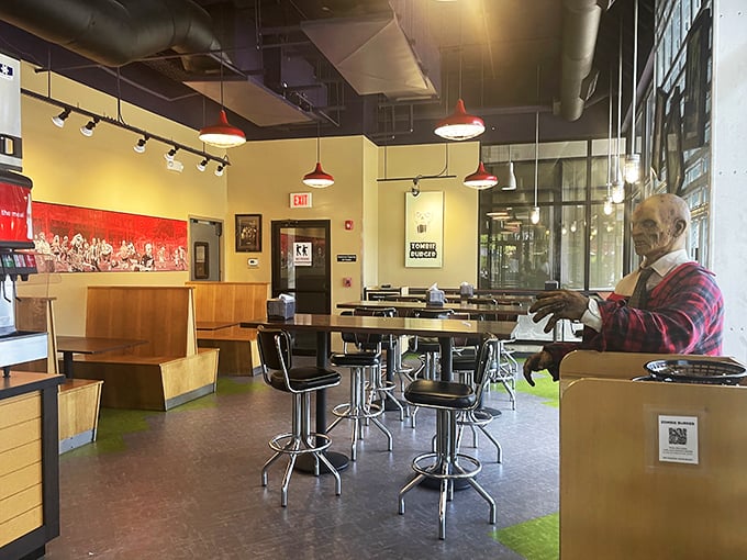 Industrial chic meets horror-movie aesthetic. The zombie mannequin isn't judging your order, but he might be eyeing your brains for dessert.