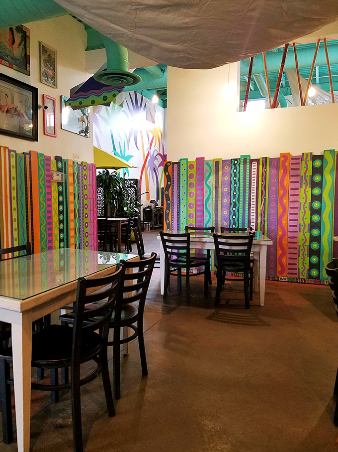 Colorful dividers creating pockets of tropical paradise inside&mdash;like someone took a Gauguin painting and turned it into a dining experience.