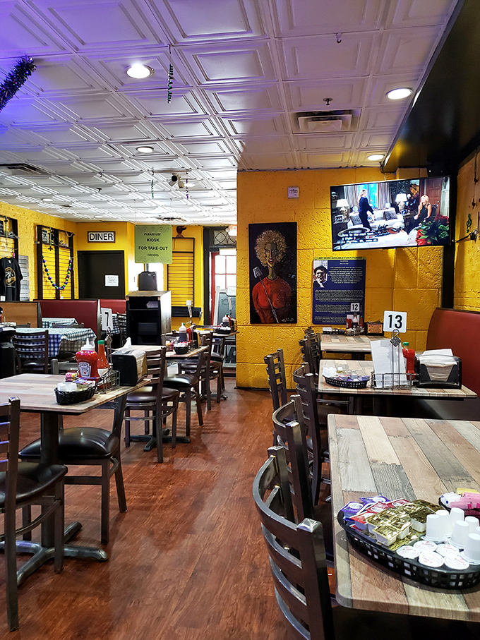 Sunshine-yellow walls and classic New Orleans artwork create a dining room that feels like your coolest friend's kitchen.
