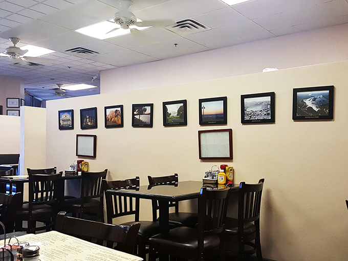The walls lined with framed landscapes create a gallery-like backdrop for the real art form happening on your plate.