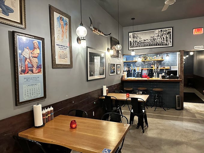 Modern industrial meets roadhouse charm with pendant lights illuminating wooden tables where barbecue memories are made daily.