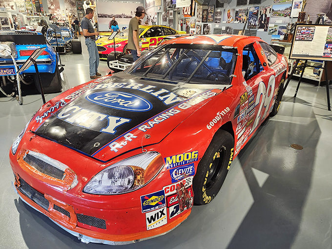 This Ford racing machine looks ready to roar to life, its sponsor decals and racing stripes a mobile billboard from racing's commercial heyday.