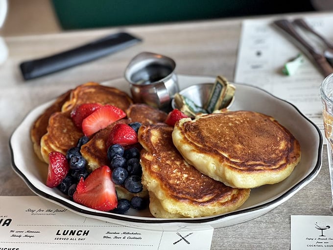 Golden pancakes that would make maple trees voluntarily surrender their syrup. The fresh berries add pops of color and bursts of tangy sweetness.