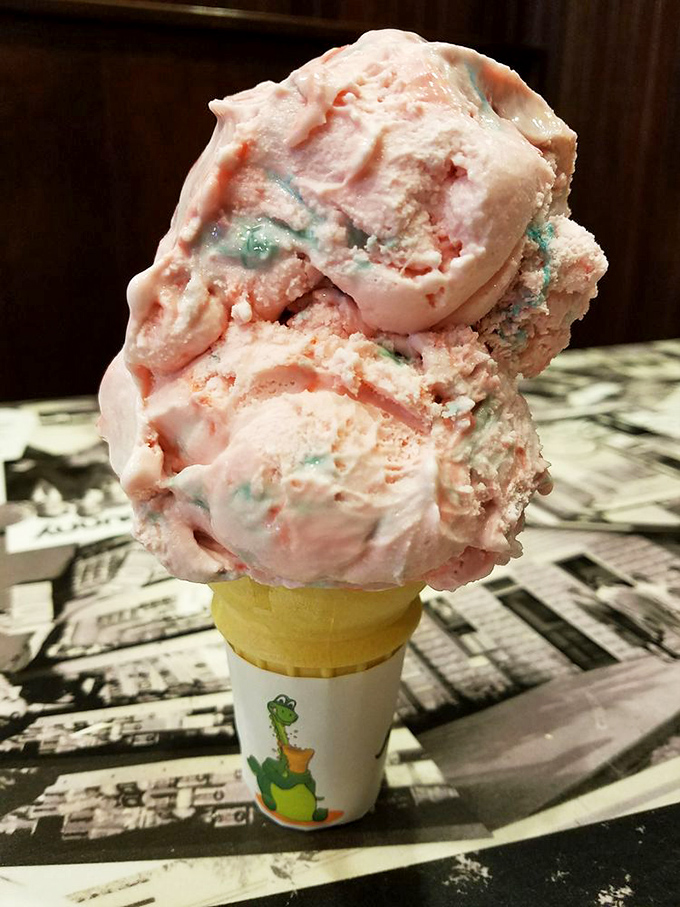 Cotton candy ice cream that looks like it was scooped directly from a carnival dream, balanced precariously on a cone that's about to experience its delicious destiny.