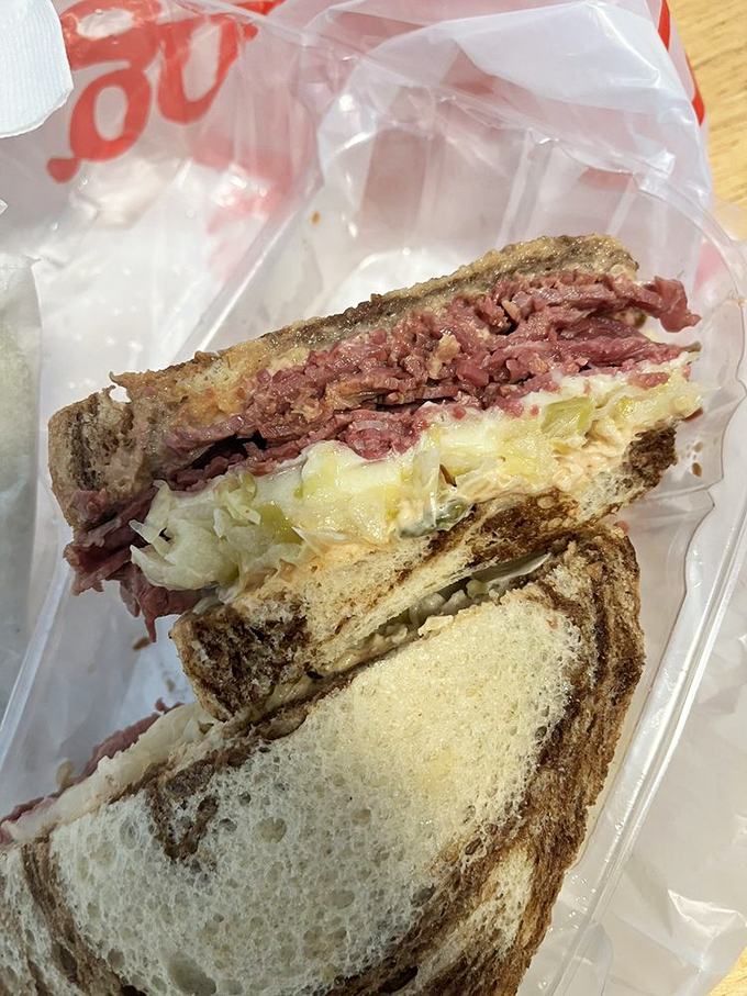 Sandwich architecture at its finest. Layers of pastrami and sauerkraut create a skyscraper of flavor that demands to be admired before demolished.