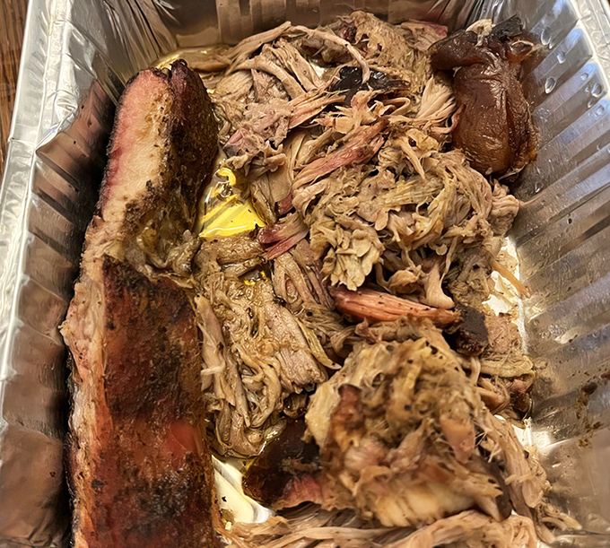 Pulled pork paradise with a side of brisket heaven. This aluminum container holds more flavor than most restaurants achieve in their entire menu.