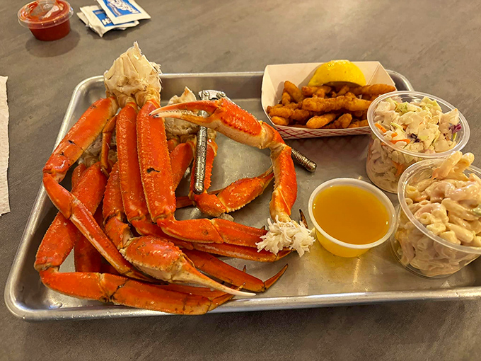Snow crab legs arranged like nature's perfect architecture. The melted butter alongside is basically liquid gold for dipping these oceanic treasures.